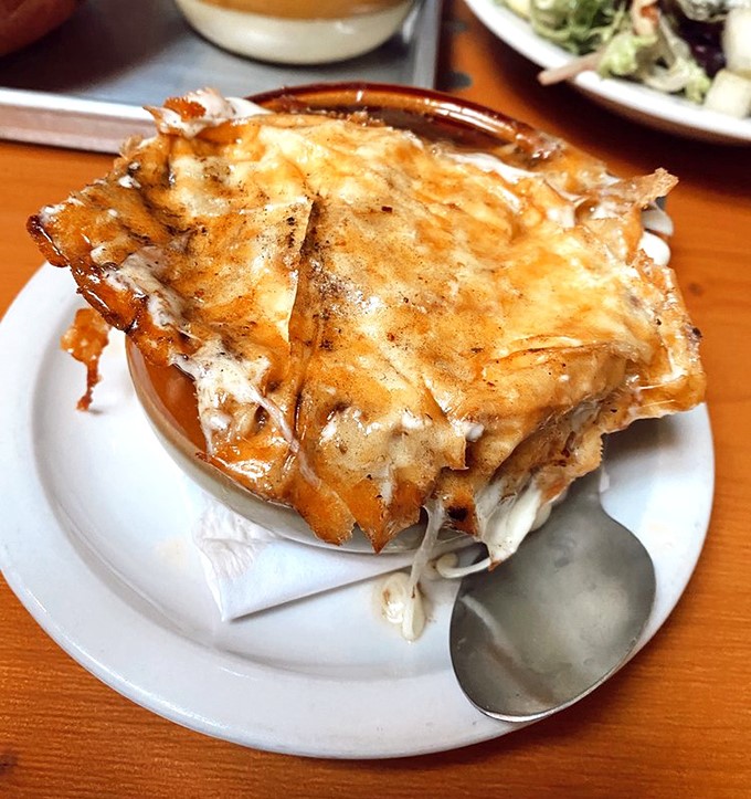 French onion soup with a cheese cap so perfect it deserves its own Instagram account and possibly talent representation.