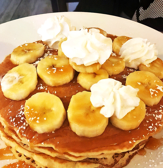 Banana pancakes that look like they were designed by someone who understands that breakfast can double as dessert without judgment.
