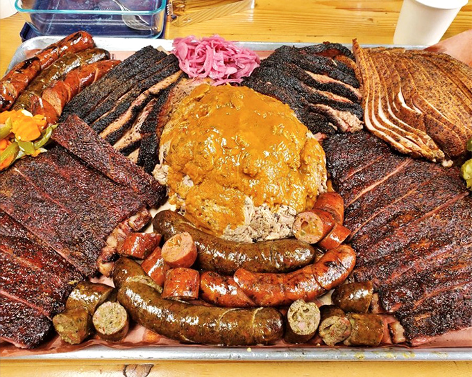 The barbecue platter that dreams are made of. A smoky landscape of brisket, ribs, sausage, and sides that could feed a small village.