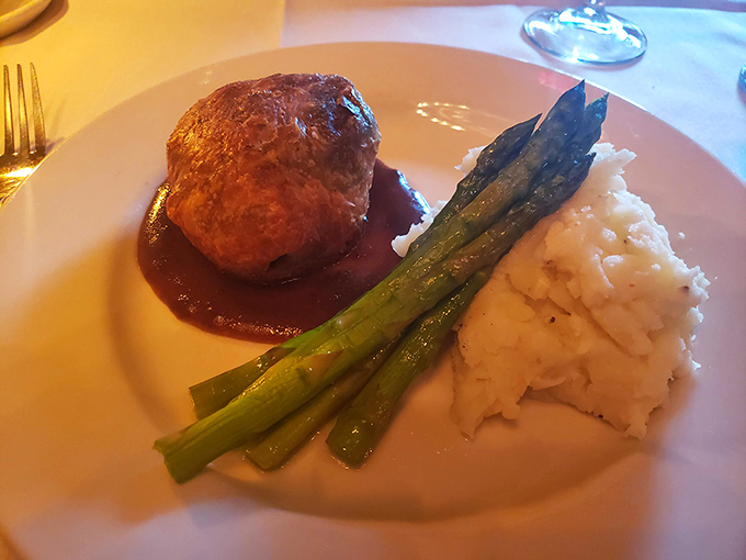 This plate whispers "special occasion" with every bite&mdash;tender beef Wellington, creamy mashed potatoes, and asparagus spears standing at attention like delicious soldiers.