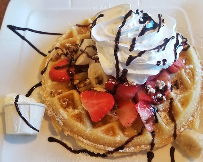 A Belgian waffle that's dressed for success with fresh strawberries, bananas, whipped cream, and chocolate drizzle&mdash;breakfast or dessert? Why choose?