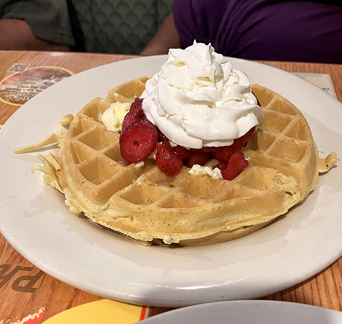 The Belgian waffle arrives like a throne for strawberries and whipped cream&mdash;a breakfast that feels like dessert without the guilt trip.