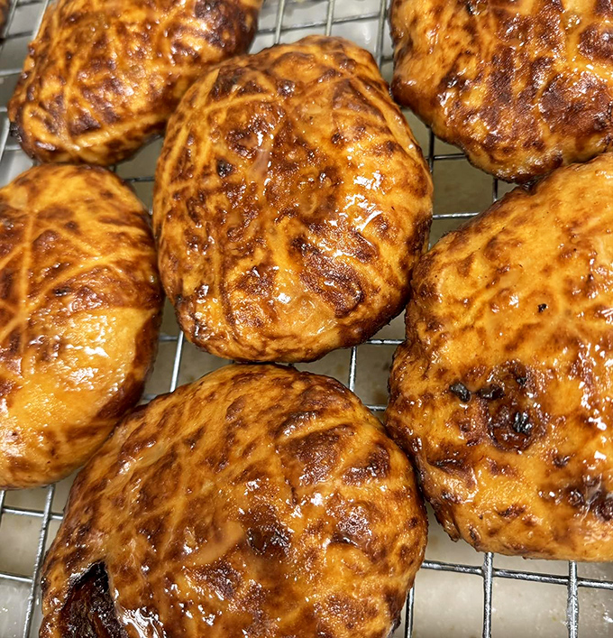 These fritters aren't just baked; they're engineered for maximum pleasure, with each spiral offering the perfect ratio of dough to sweet cinnamon glaze.