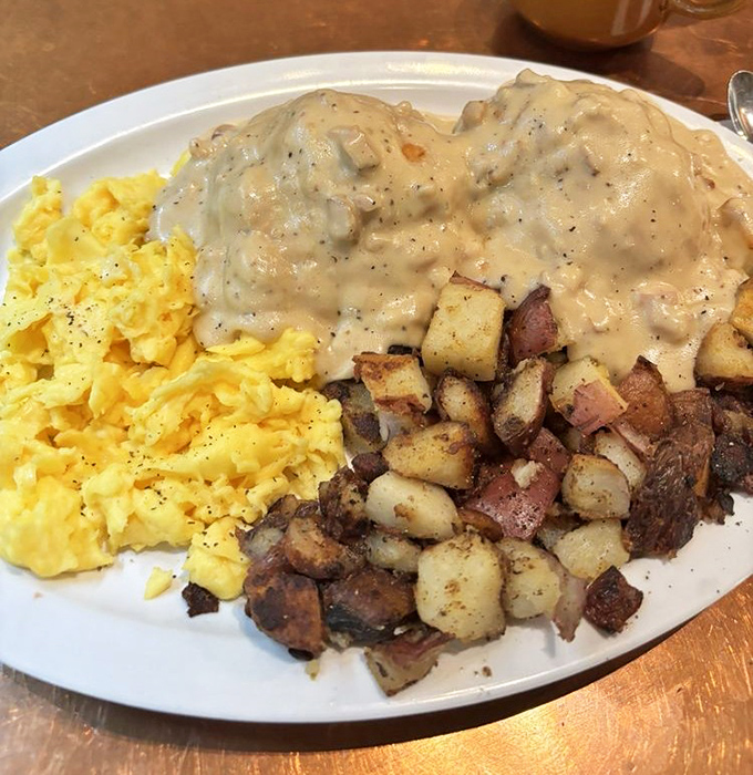 These biscuits drowning in gravy represent everything right with the world, served on a plate of pure happiness.