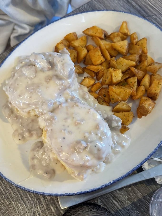 Breakfast of champions: country gravy blankets the plate like a warm Southern hug, while those home fries stand ready for their supporting role.