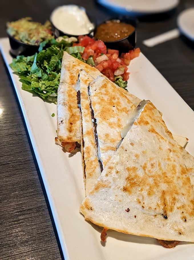 This quesadilla doesn't just cross borders &ndash; it erases them. Crispy exterior, melty interior, and enough fillings to require a structural engineer's approval.