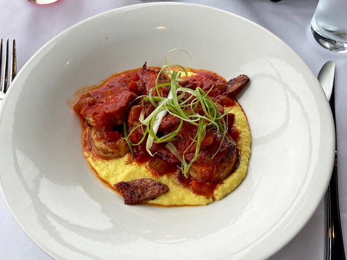 Shrimp and grits elevated to an art form. The vibrant tomato sauce and delicate microgreens prove seafood and comfort food aren't mutually exclusive.