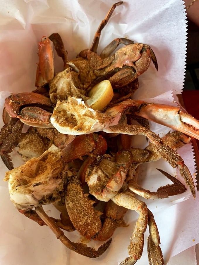 Seasoned blue crabs on parchment paper&mdash;nature's puzzle box where the reward for your efforts is sweet, succulent meat.