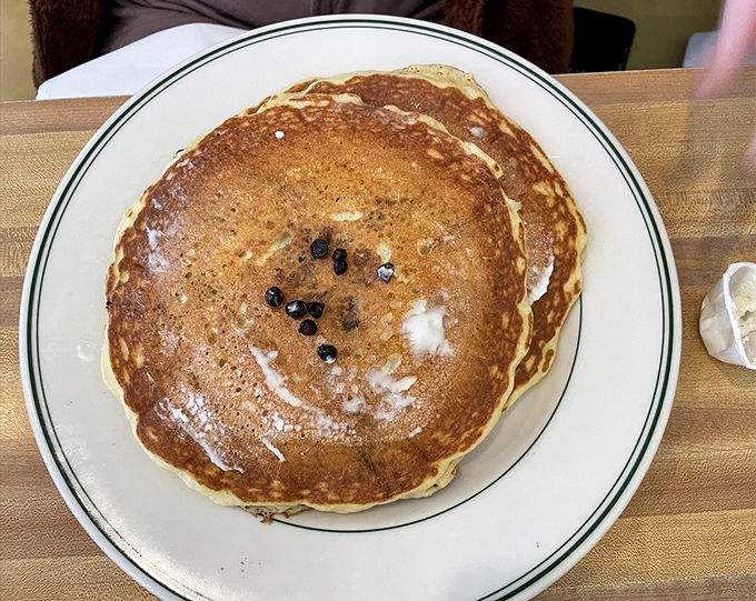 A lone blueberry pancake with the perfect golden hue—like a breakfast moon with delicious craters waiting to be filled with syrup.