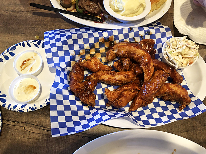 Wings that have clearly been introduced to smoke before sauce, creating flavor that goes all the way to the bone. Blue checkered paper never looked so good.