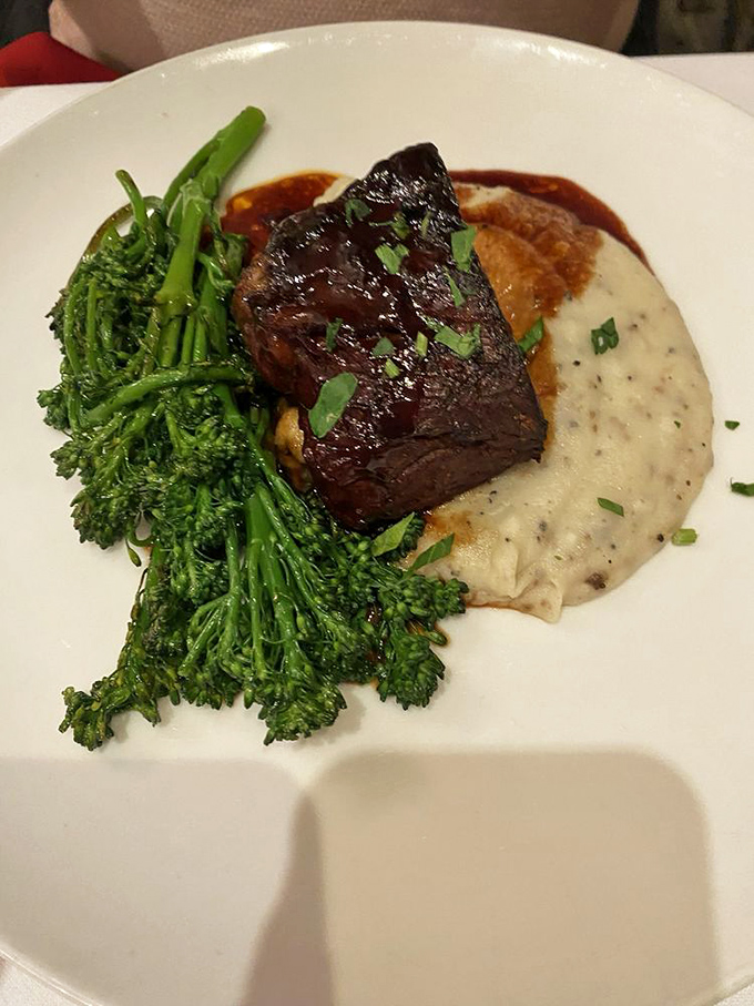 Braised short ribs nestle against vibrant broccolini like old friends sharing secrets over a perfectly orchestrated dinner date gone absolutely right.