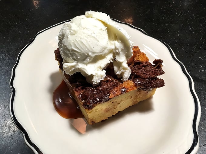 Bread pudding crowned with vanilla ice cream—comfort food elevated to art form, proving nostalgia tastes even better than you remember.
