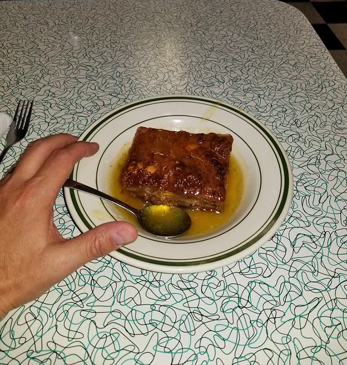 This bread pudding isn't just dessert, it's a warm hug in food form, swimming in a buttery sauce that would make your grandmother weep with joy.