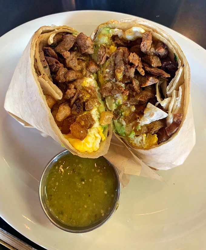 This breakfast burrito weighs more than a newborn and delivers twice the joy, salsa verde on standby.