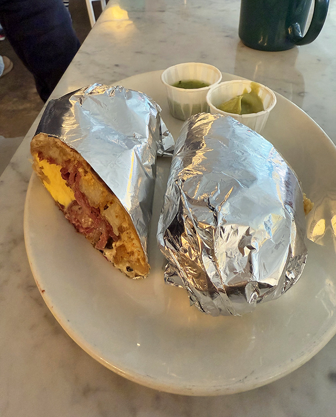 Breakfast burritos wrapped in foil like precious gifts, with those little cups of green sauce standing by like loyal sidekicks.