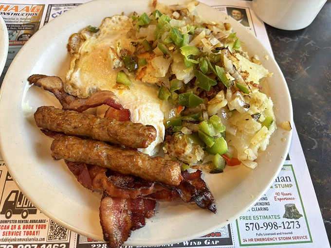 The breakfast holy trinity&mdash;eggs, hash browns, and breakfast meat&mdash;arranged with the precision of a Renaissance painting.