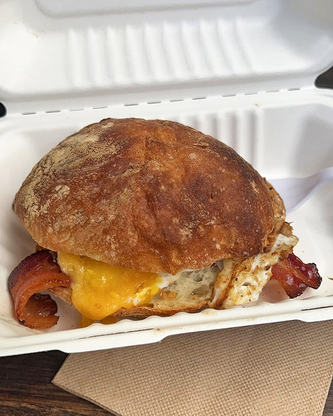 Breakfast sandwich perfection: where house-cured bacon meets melty cheese in a morning romance that puts your coffee to shame.
