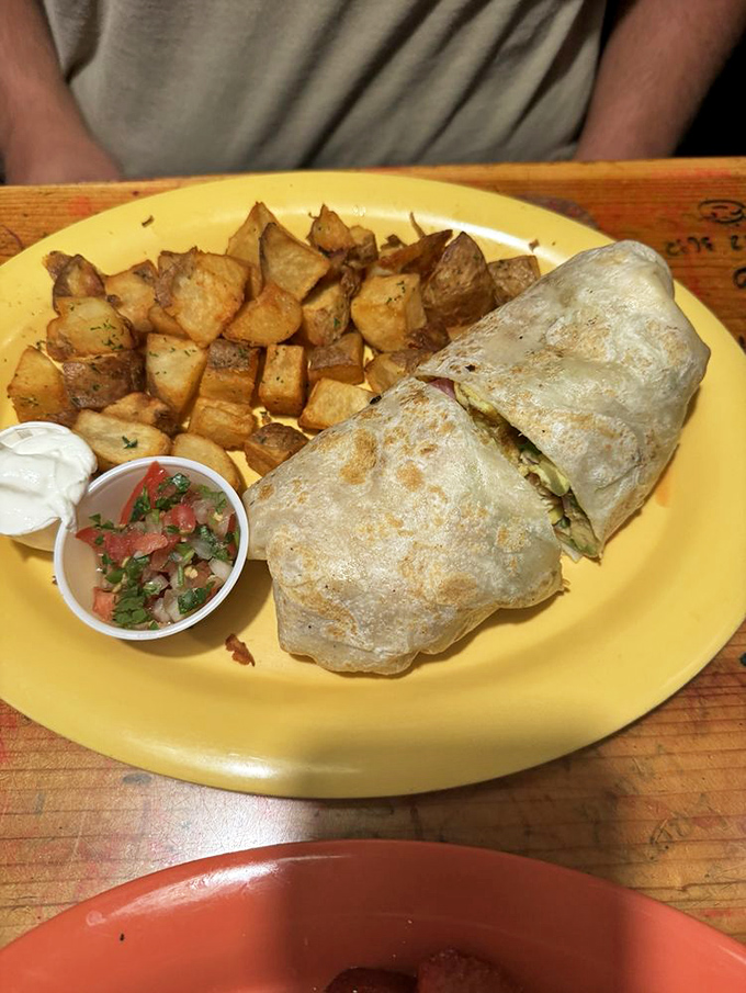 This breakfast burrito isn't messing around&mdash;a tortilla-wrapped treasure chest filled with morning delights and served with perfectly seasoned home fries.