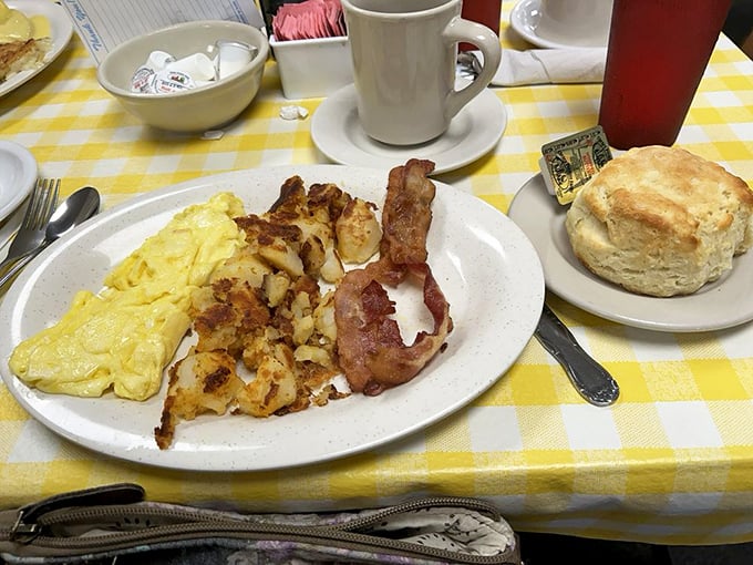 The breakfast trinity &ndash; fluffy scrambled eggs, golden hash browns, and bacon cooked to that perfect point between chewy and crisp, with a biscuit standing by.