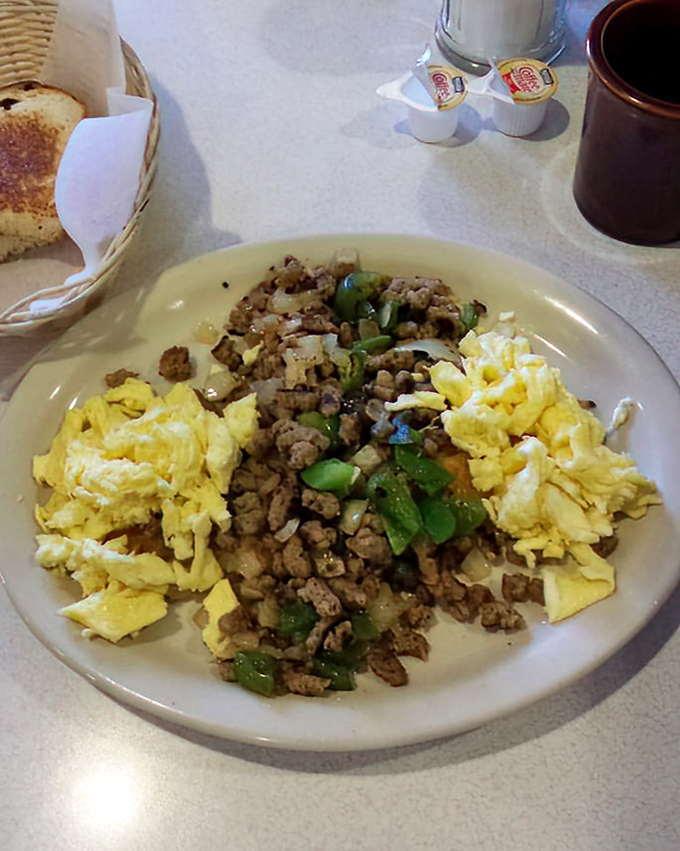 Ground meat, peppers, and eggs dancing together on a plate. This hearty breakfast hash speaks the universal language of "you'll need a nap later."