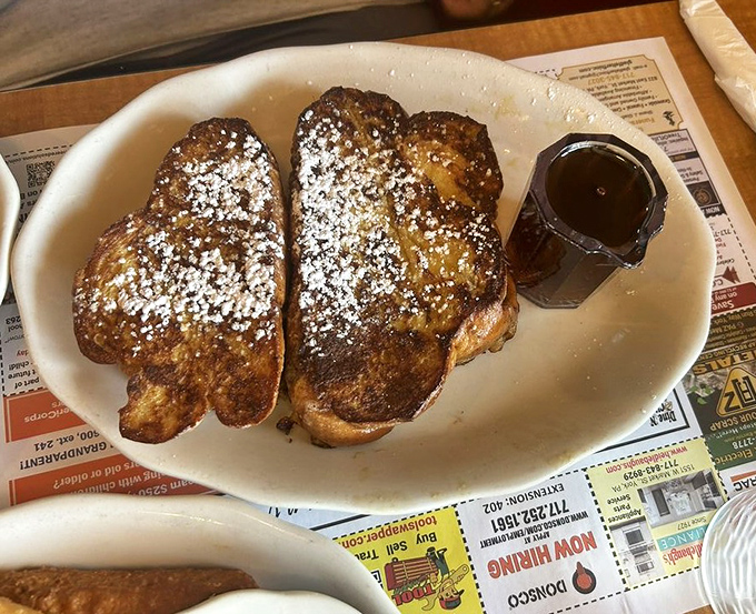 French toast that's achieved celebrity status&mdash;golden, dusted with powdered sugar, and waiting for its maple syrup paparazzi moment.