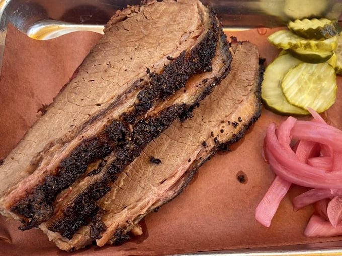 Brisket slices sporting that coveted pink smoke ring. The kind of meat that makes Texans nod in respectful approval.
