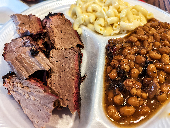 Brisket with that telltale pink smoke ring paired with beans that have clearly been simmering alongside the meat all day.
