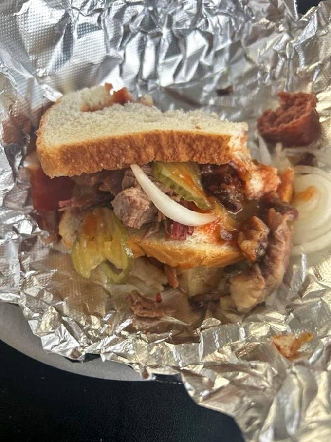 This isn't just a sandwich; it's an architectural marvel of tender brisket, pickles, onions, and white bread&mdash;the Parthenon of portable barbecue pleasure.