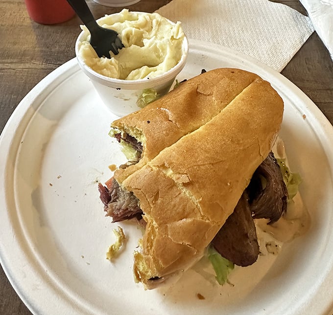 This brisket sandwich isn't just a meal – it's an architectural marvel balancing meat, bread, and the laws of physics.