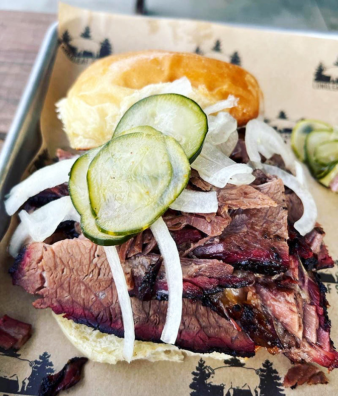 This brisket sandwich is architectural perfection &ndash; layers of smoke-kissed beef with pickled cucumber and onion for a perfect balance of rich and bright.