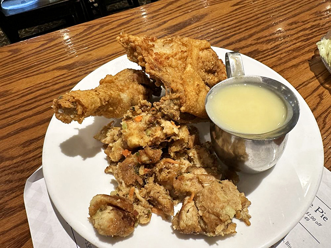 Broasted chicken so golden and crispy it deserves its own trophy, served with a side of gravy that could make cardboard taste good.