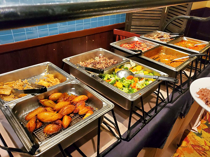 A buffet lineup that makes decision-making the hardest part of your meal—those golden plantains are practically winking at you.
