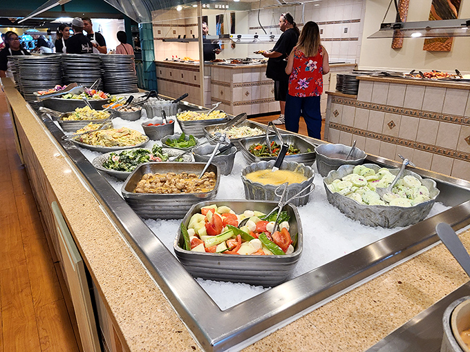 A buffet spread that makes decision-making the hardest workout you'll get today. Each metal pan holds a different delicious commitment.