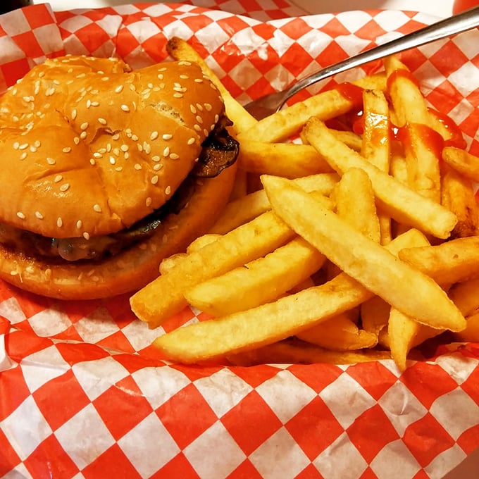 A burger and fries on a red-checkered paper&mdash;proof that happiness doesn't need white tablecloths or servers who introduce themselves as "your guide."