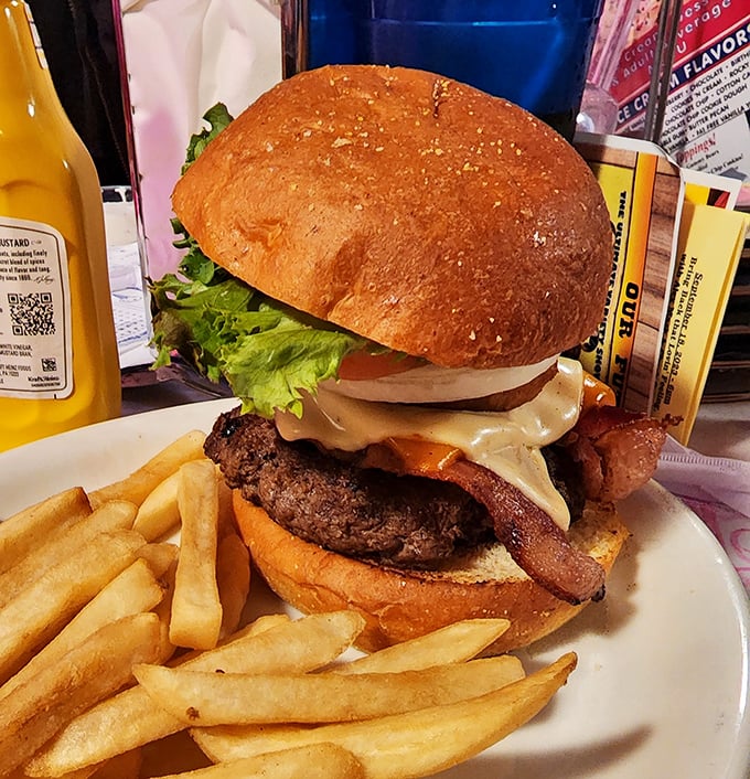 This isn't just a burger—it's architecture. A hand-formed patty, melty cheese, and bacon on a toasted bun that somehow defies the laws of structural engineering.