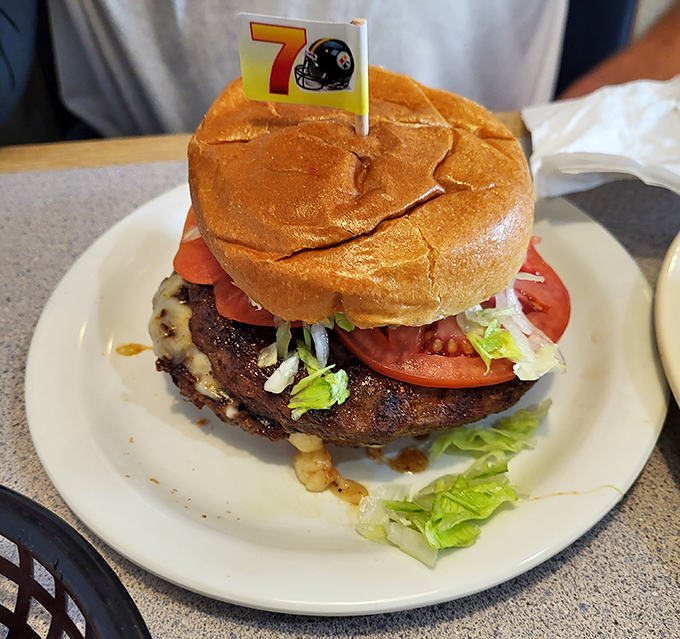 This burger isn't just wearing a Steelers flag&mdash;it's declaring itself MVP-worthy with a perfectly charred patty and garden-fresh toppings. Tailgate dreams realized.