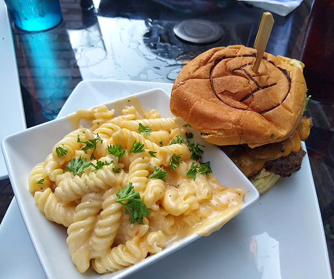The burger arrives with a side of mac and cheese so good you'll debate which deserves your attention first&mdash;a delicious dilemma indeed.