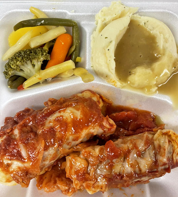 Cabbage rolls that could end family feuds—tender cabbage embracing seasoned meat and rice, all bathed in a tomato sauce that demands to be sopped up.