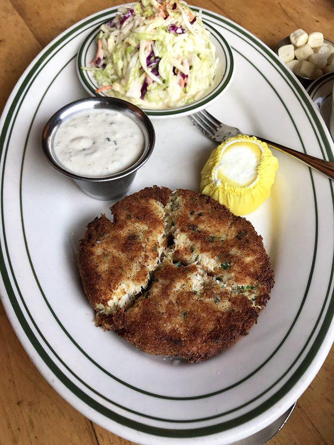 This golden-crusted crab cake isn't hiding behind fillers&mdash;it's almost all crab, crispy outside and sweet within, served with classic accompaniments that let the seafood shine.