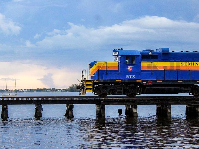 The train crosses the Caloosahatchee River at sunset, creating a postcard-worthy moment that no Instagram filter could possibly improve.