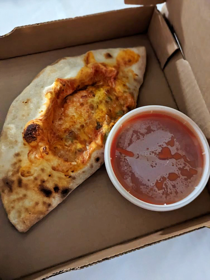 Not quite pizza, not quite sandwich&mdash;this calzone with its side of marinara is the culinary equivalent of having your cake and dunking it too.