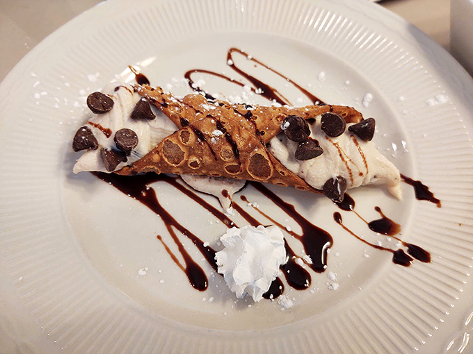 A proper cannoli should shatter slightly when bitten, revealing a creamy interior &ndash; this beauty delivers with chocolate chips and a drizzle of sauce.