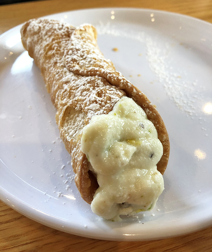 These cannoli shells crack like autumn leaves, revealing sweet ricotta dreams inside every bite.
