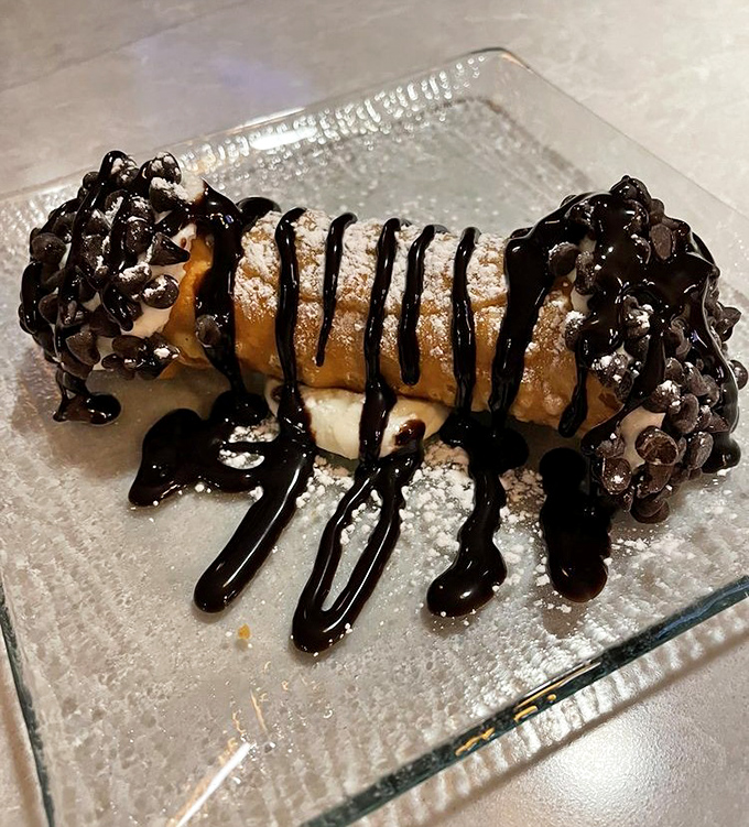 The infamous cannoli in all its glory&mdash;chocolate-dipped ends, powdered sugar dusting, and that chocolate drizzle that's worth every mile of the drive.