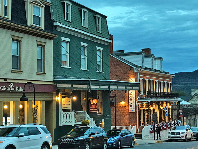 Evening transforms Bedford's storefronts into a cozy tableau of warm lights and historic architecture that whispers "come in, stay awhile."