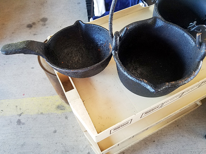 Seasoned cast iron cookware sits patiently, ready for its next kitchen adventure. These culinary workhorses have stories to tell and decades more cornbread to bake.