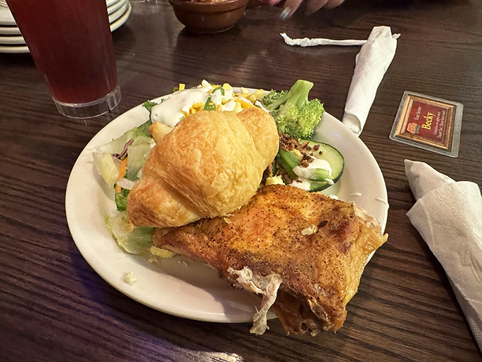 The holy trinity of Branson dining: golden-fried catfish, buttery croissant, and a side salad to maintain the illusion of healthful balance.