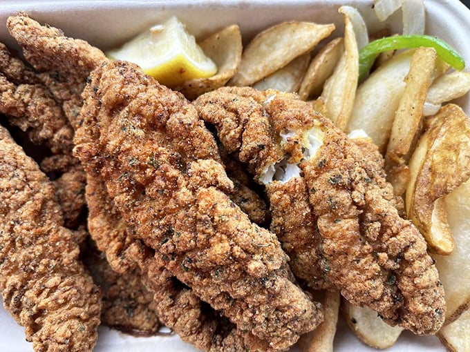 Catfish elevated from humble river dweller to crispy, golden-brown royalty, served with the simple dignity of a lemon wedge.