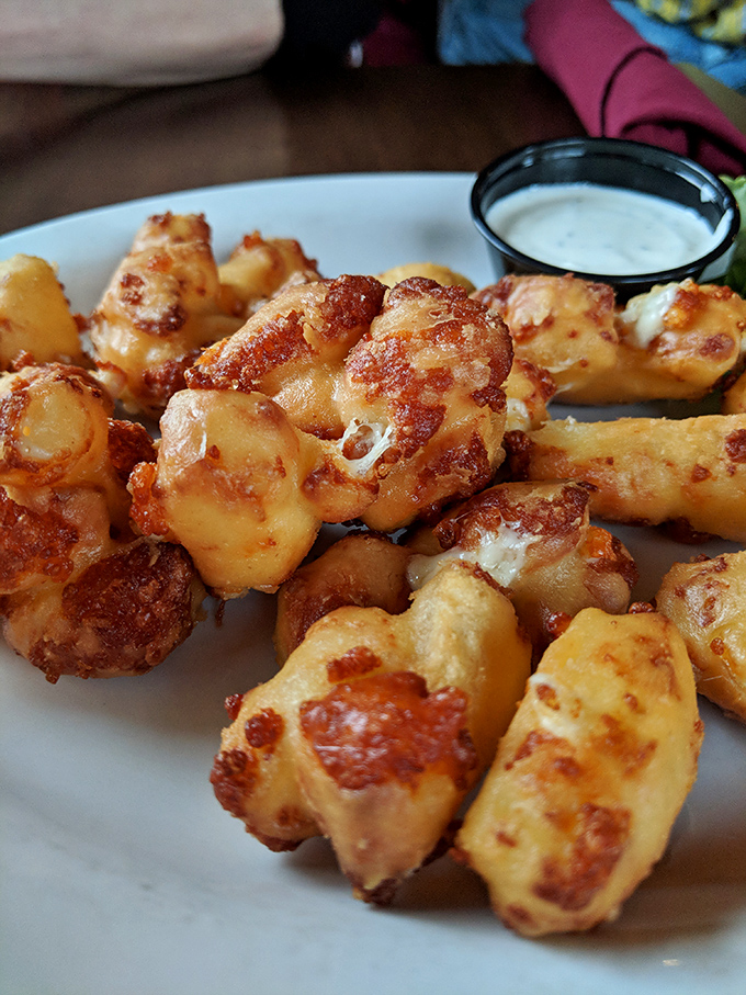 These aren't just cheese curds&mdash;they're little golden nuggets of Wisconsin's soul, crispy outside, melty inside, and utterly impossible to stop eating.