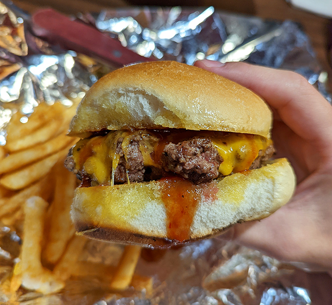 This isn't just a burger &ndash; it's a hand-held celebration. Melted cheese cascading down seasoned beef with sauce that demands both napkins and respect.